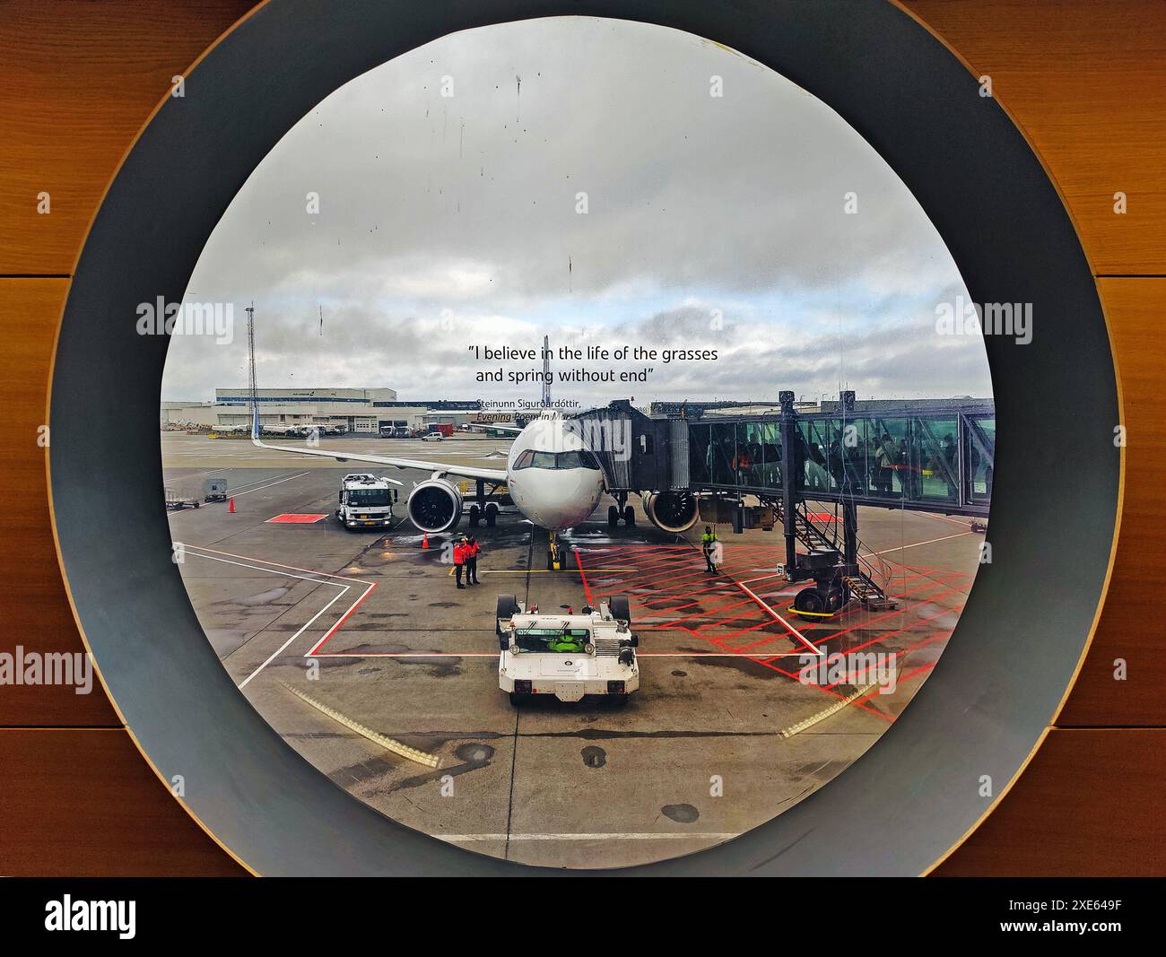 View from a round window of an airplane on the tarmac, Keflavik ...