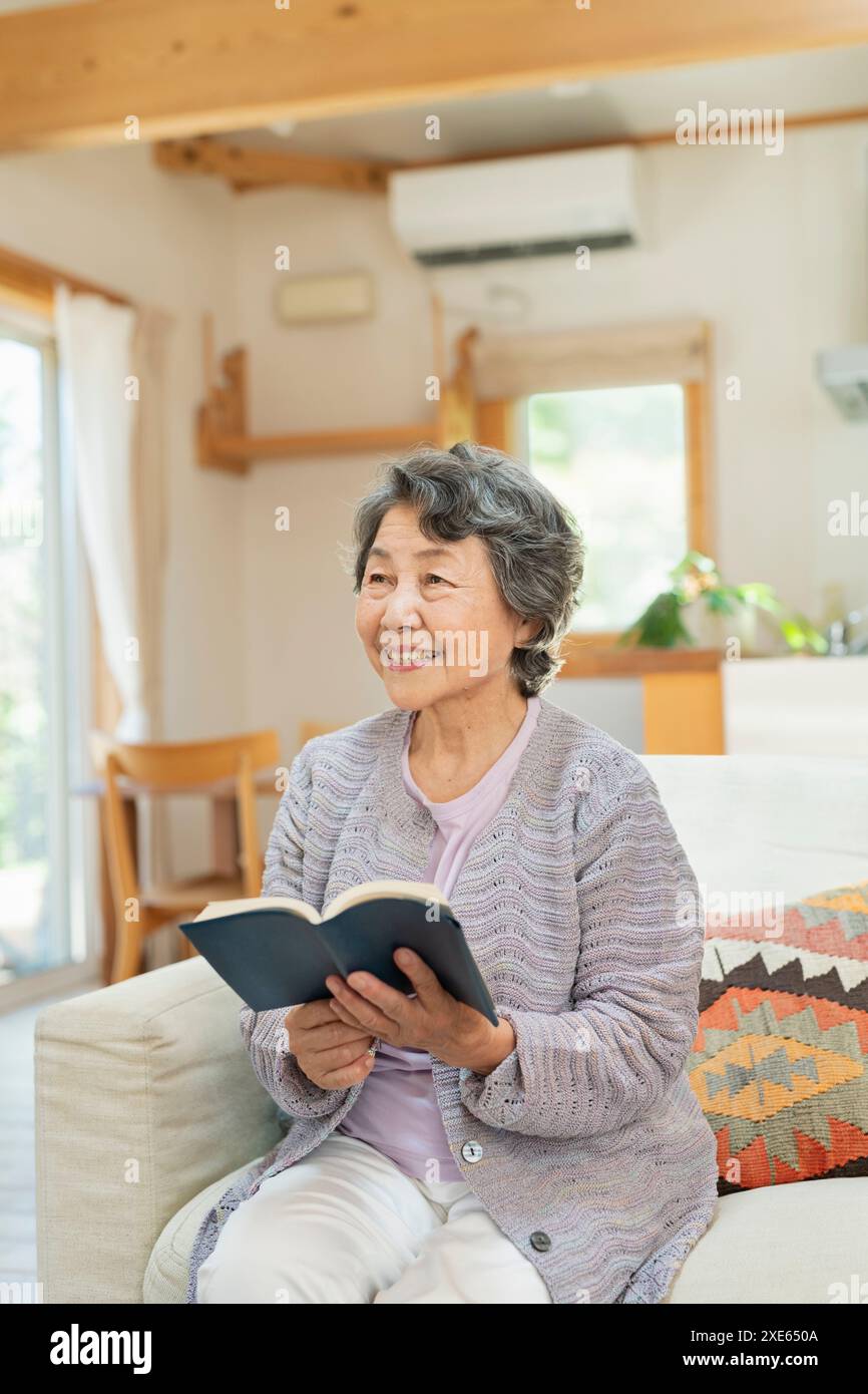 Senior woman reading a book Stock Photo - Alamy