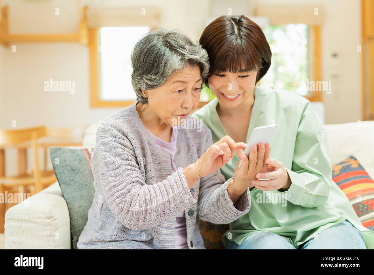 Senior woman teaching her grandson how to use a smartphone Stock Photo ...