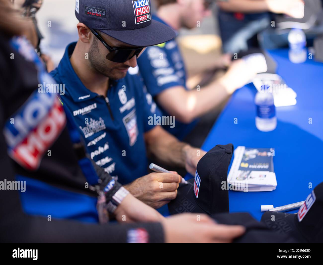 motorbike race rider giving autograph to fans Stock Photo - Alamy