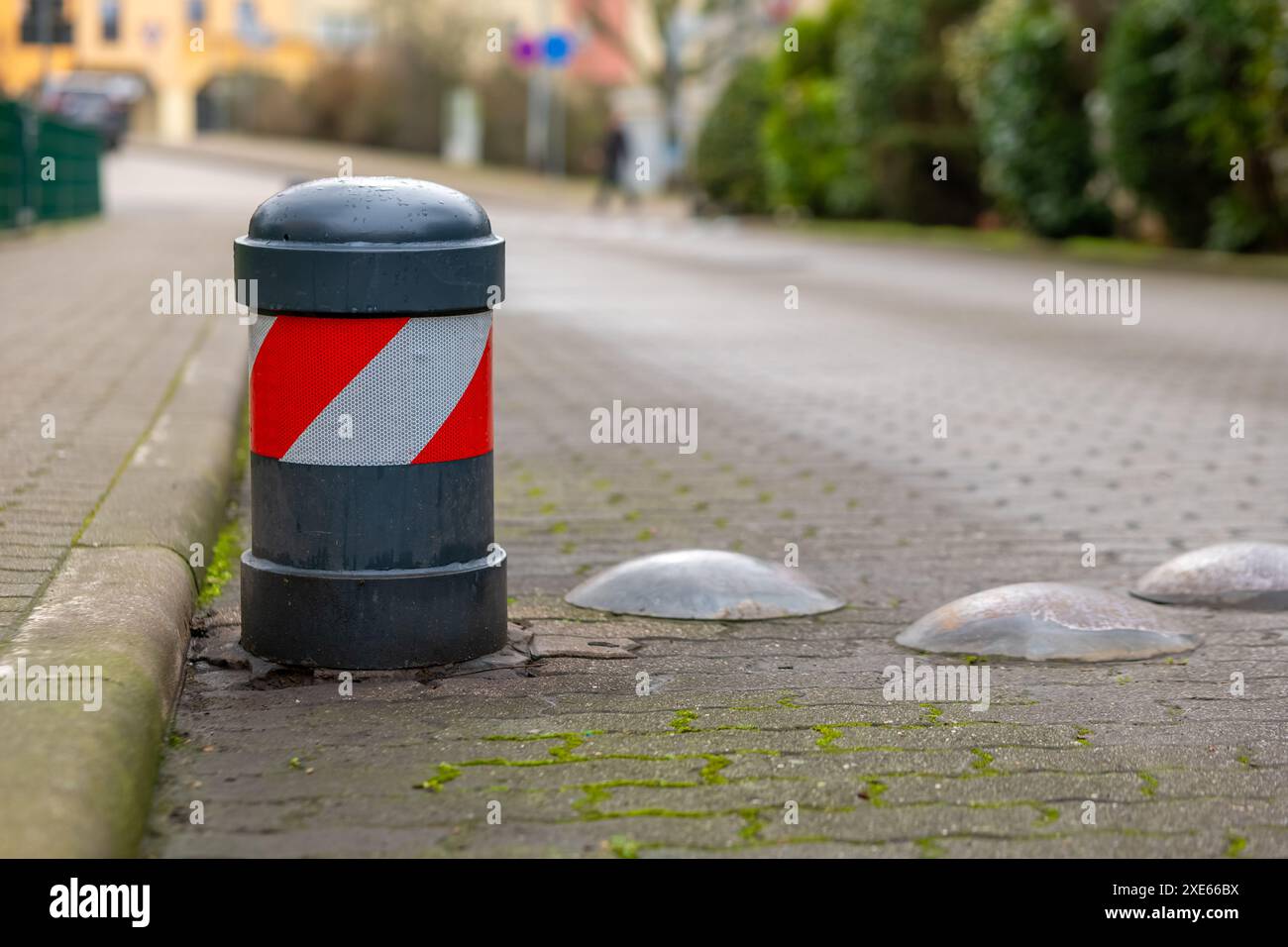 A bollard on a road to warn traffic Stock Photo - Alamy