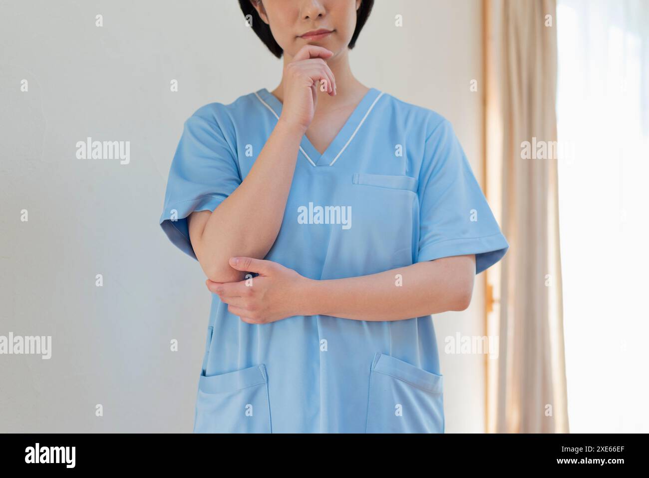 Distressed female health care worker Stock Photo - Alamy