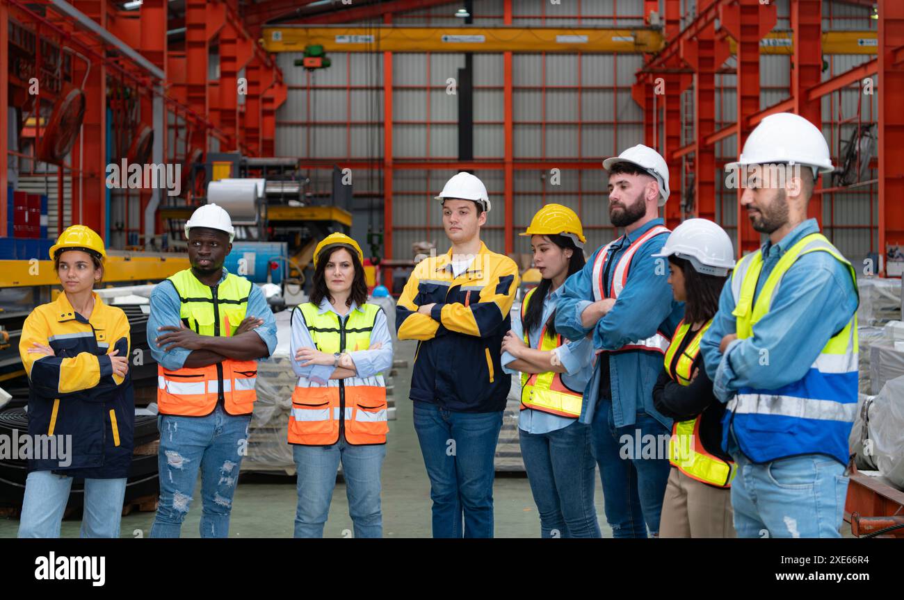 Portrait of confident factory workers standing with arms crossed and ...