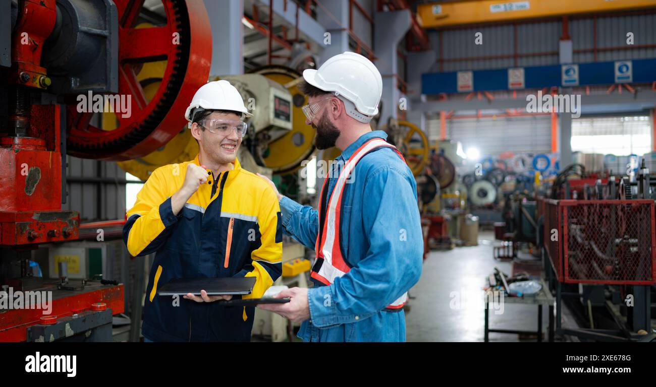 Engineer and technician discussing machinery in factory to plan ...