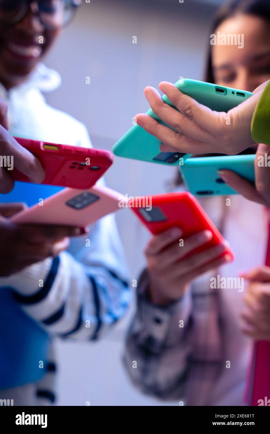 Students having fun with mobile phones creating content on social media ...