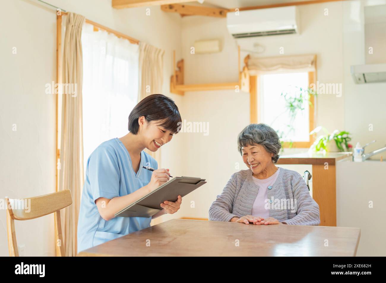 Female health care worker listening to a user Stock Photo - Alamy