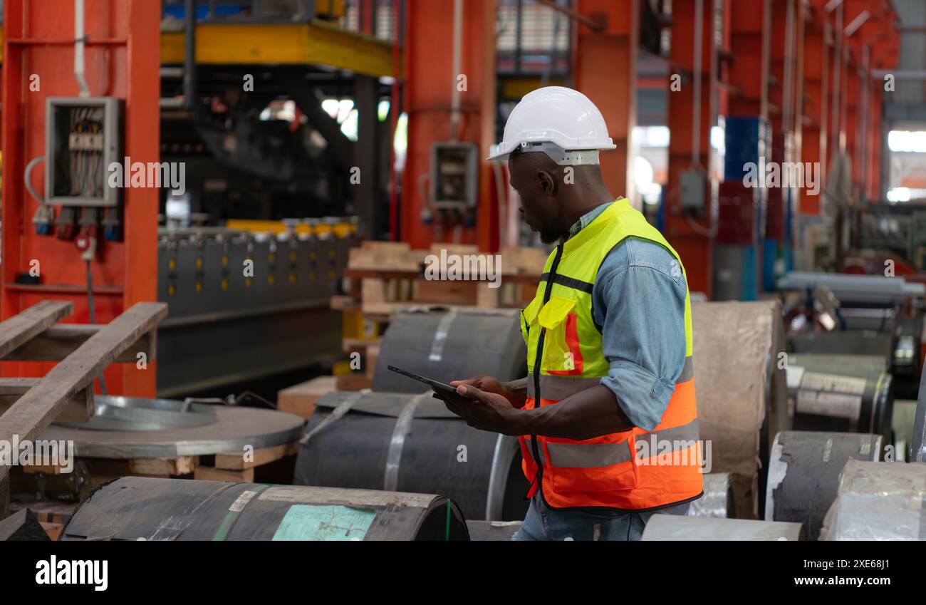Front view of young man worker using digital tablet to check stock in ...