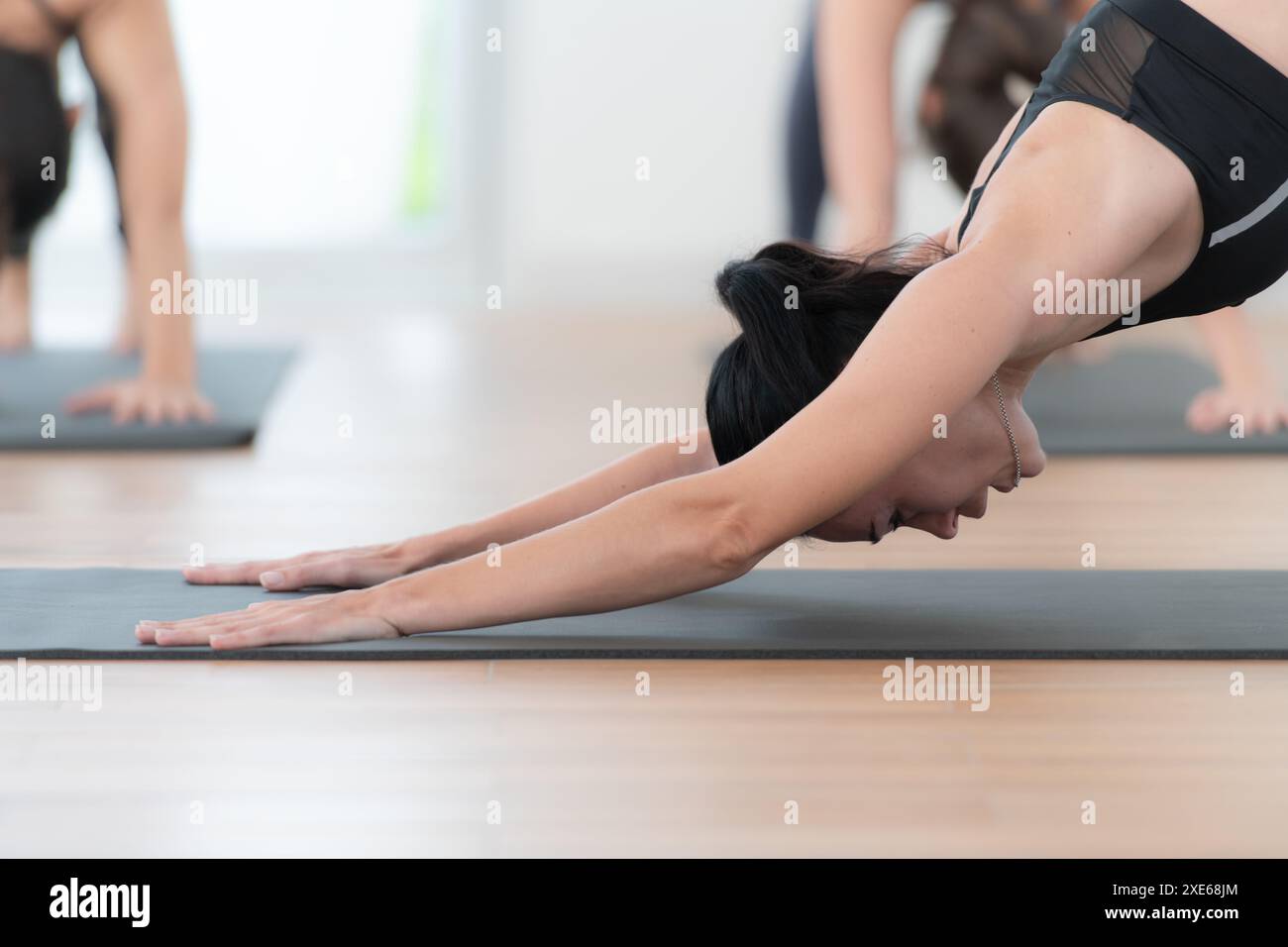 Group of people practicing yoga in a studio. Yoga class concept Stock ...