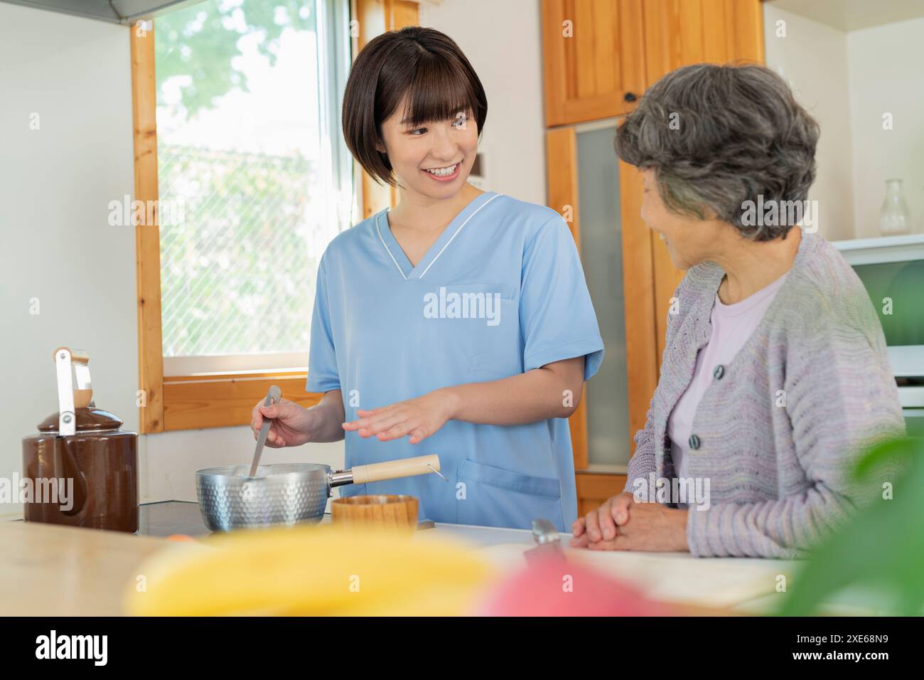 Female caregiver preparing a meal with a patient Stock Photo - Alamy