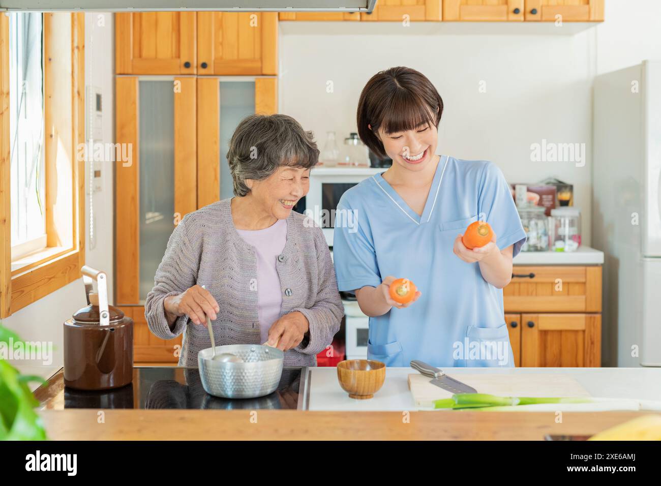 Female caregiver preparing a meal with a patient Stock Photo - Alamy