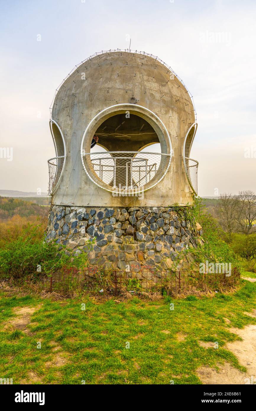 A unique modern concrete lookout tower with large circular windows ...