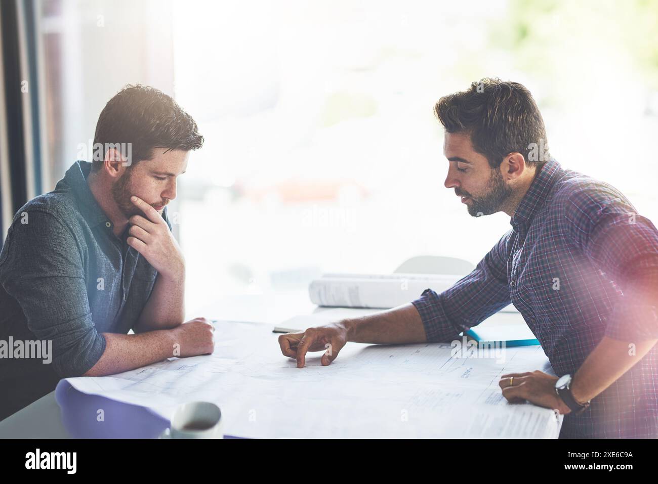 Meeting, blueprint and business men for architecture, urban planning ...