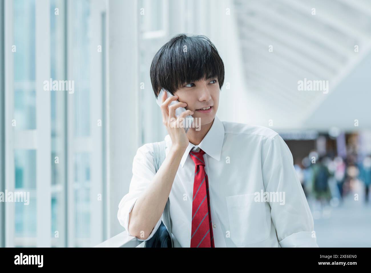 High school boy making a phone call on his way to school Stock Photo ...