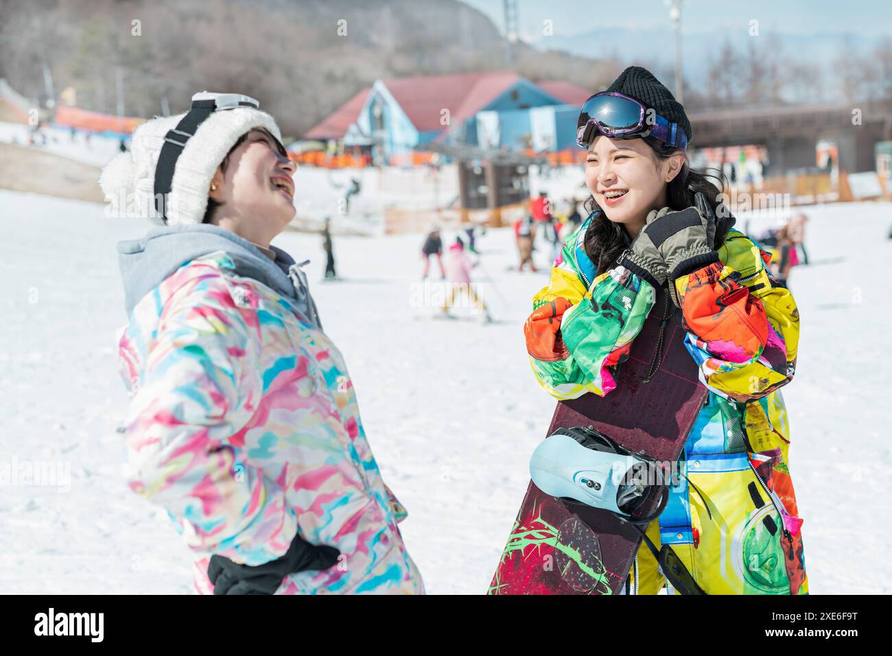Woman snowboarding with friends Stock Photo - Alamy