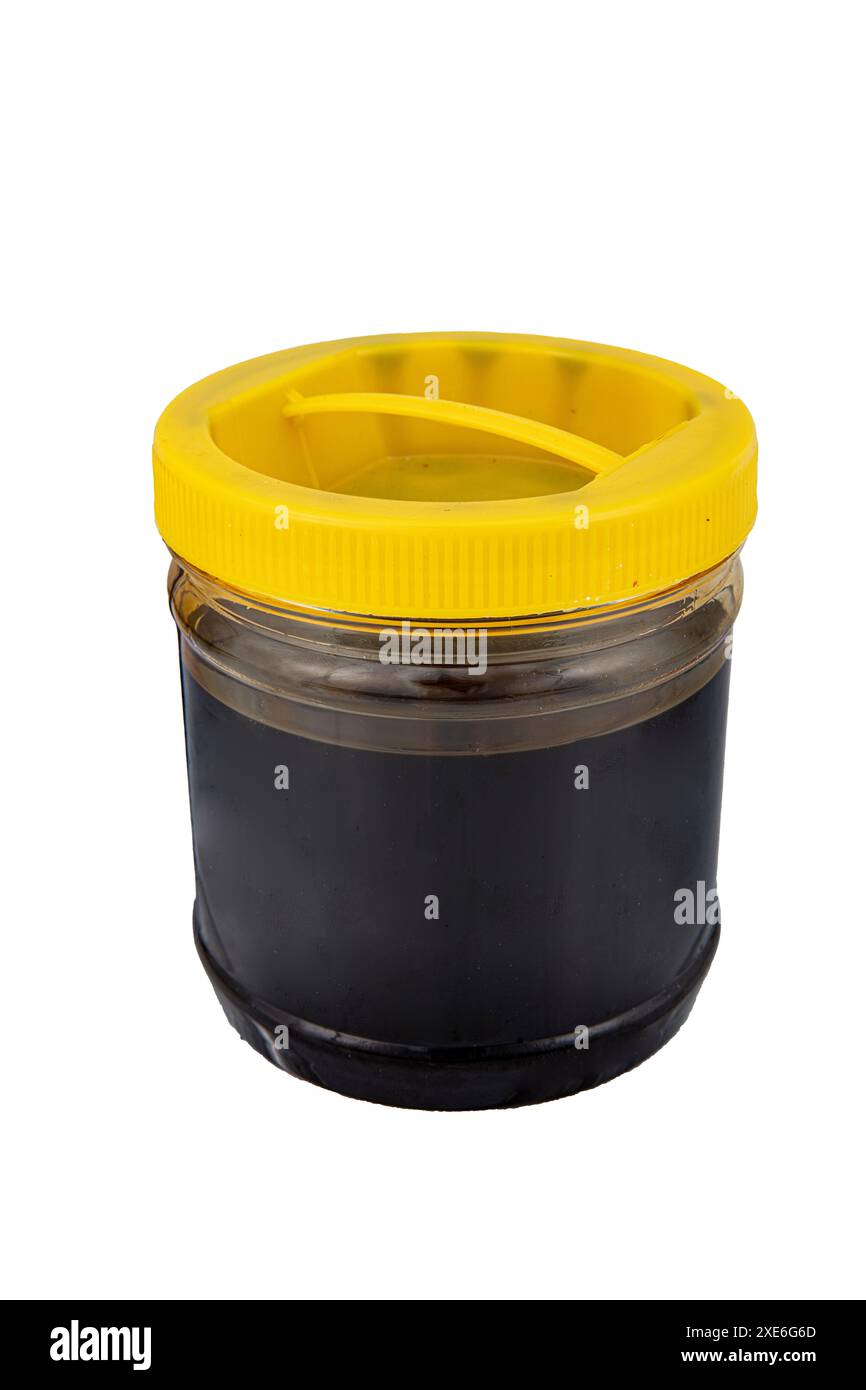 Grape molasses in a plastic jar on a white background. Jar of grape ...