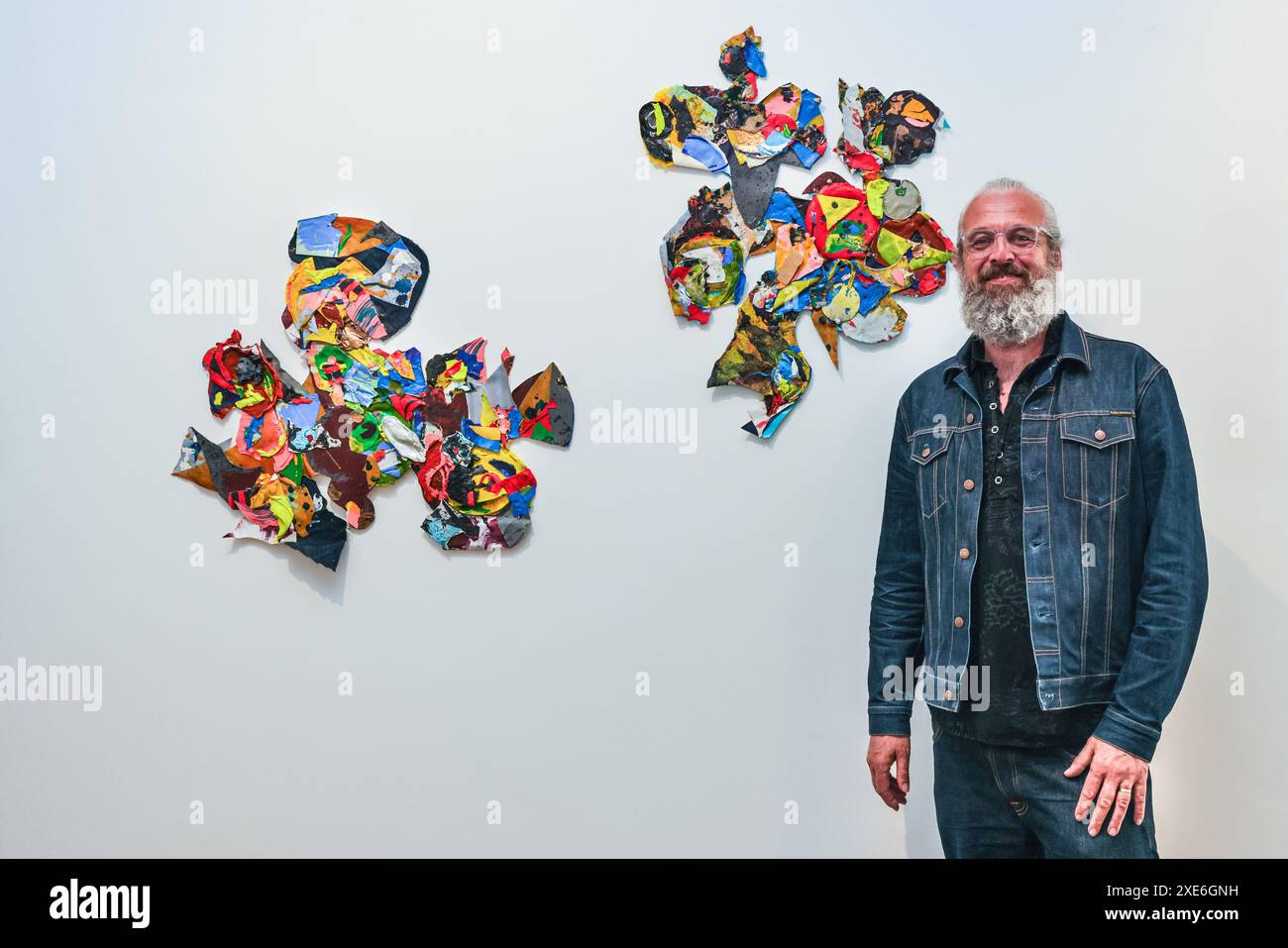London, UK. 26th June, 2024. Artist John Bunker poses with some of his ...