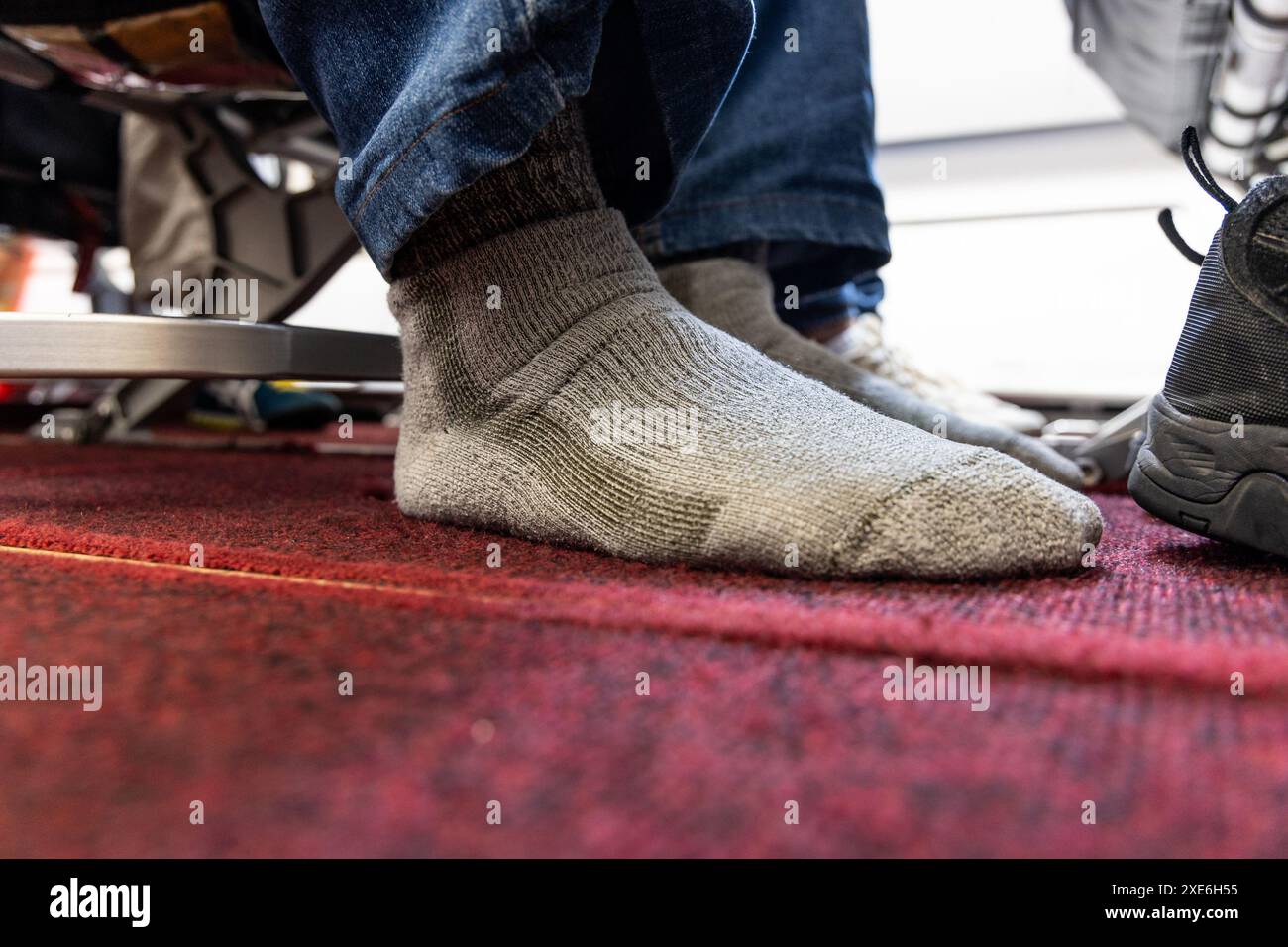 AIrplane passenger removed shoes in cabin to relax feet during long ...
