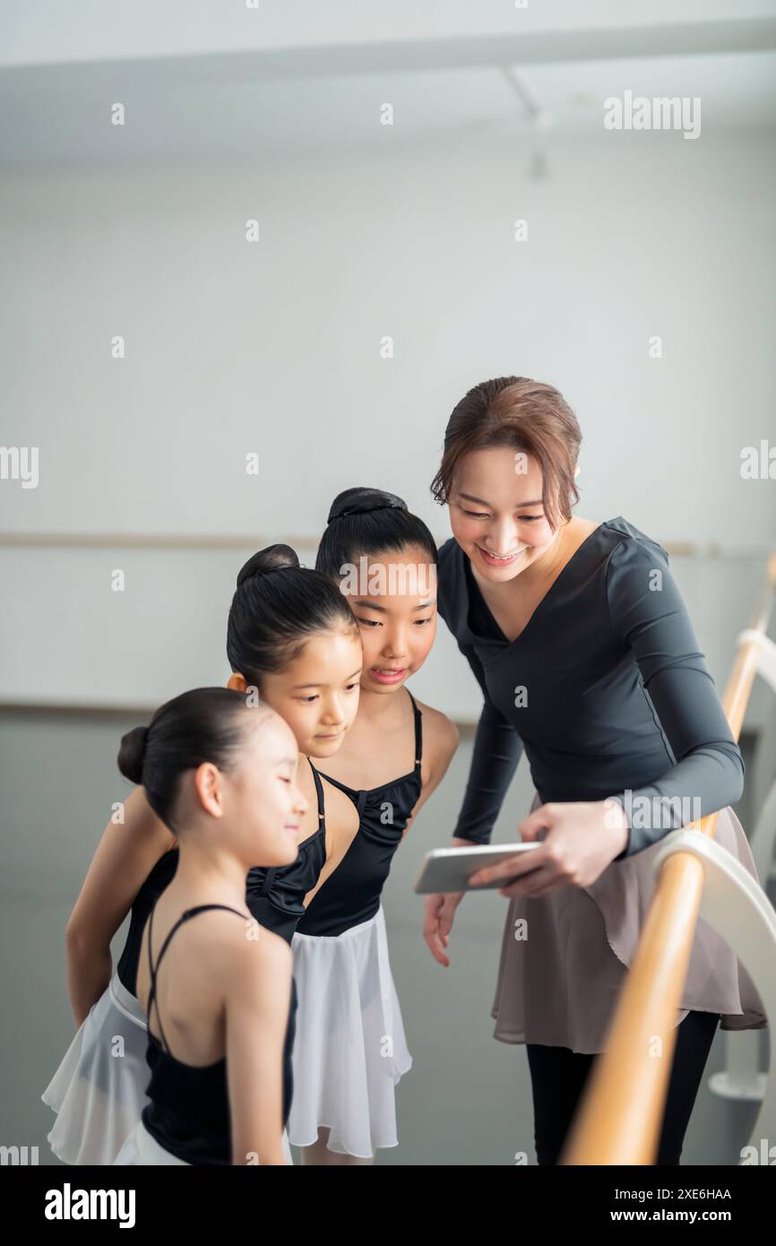 Ballet class Instructor and student watching video Stock Photo - Alamy