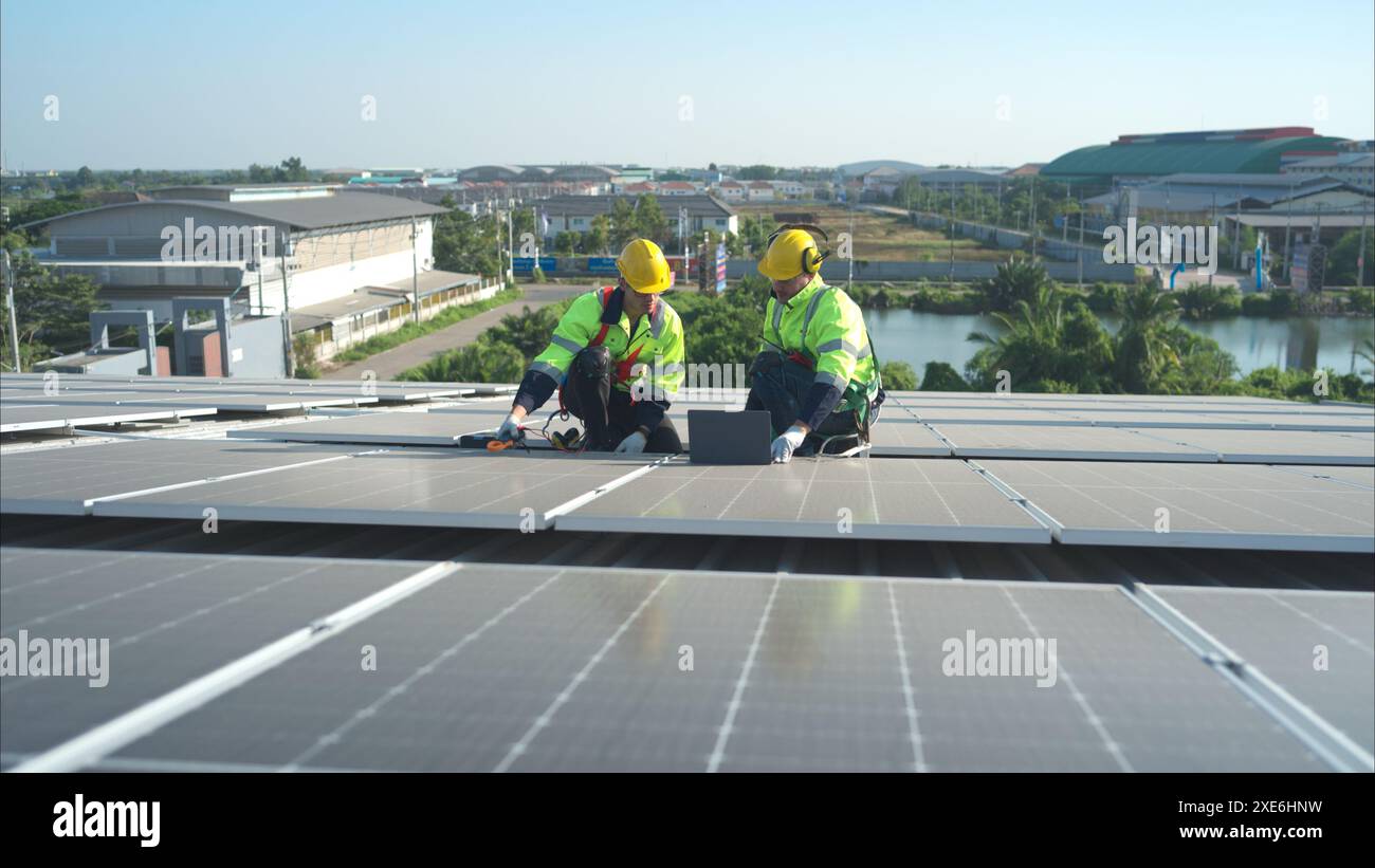 Both of technicians is installing solar panels on the roof of the ...