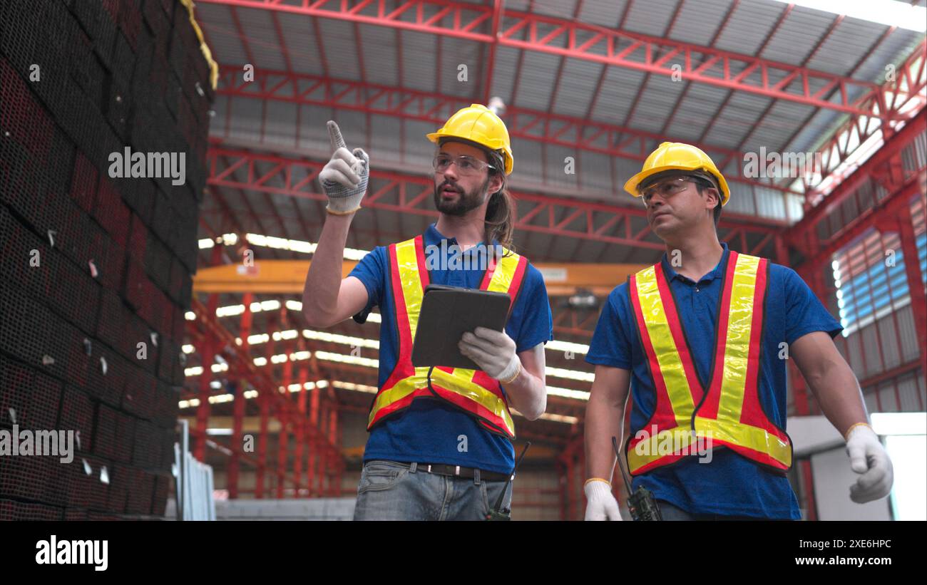Warehouse workers in hard hats and helmets, Inspect and count steel in ...