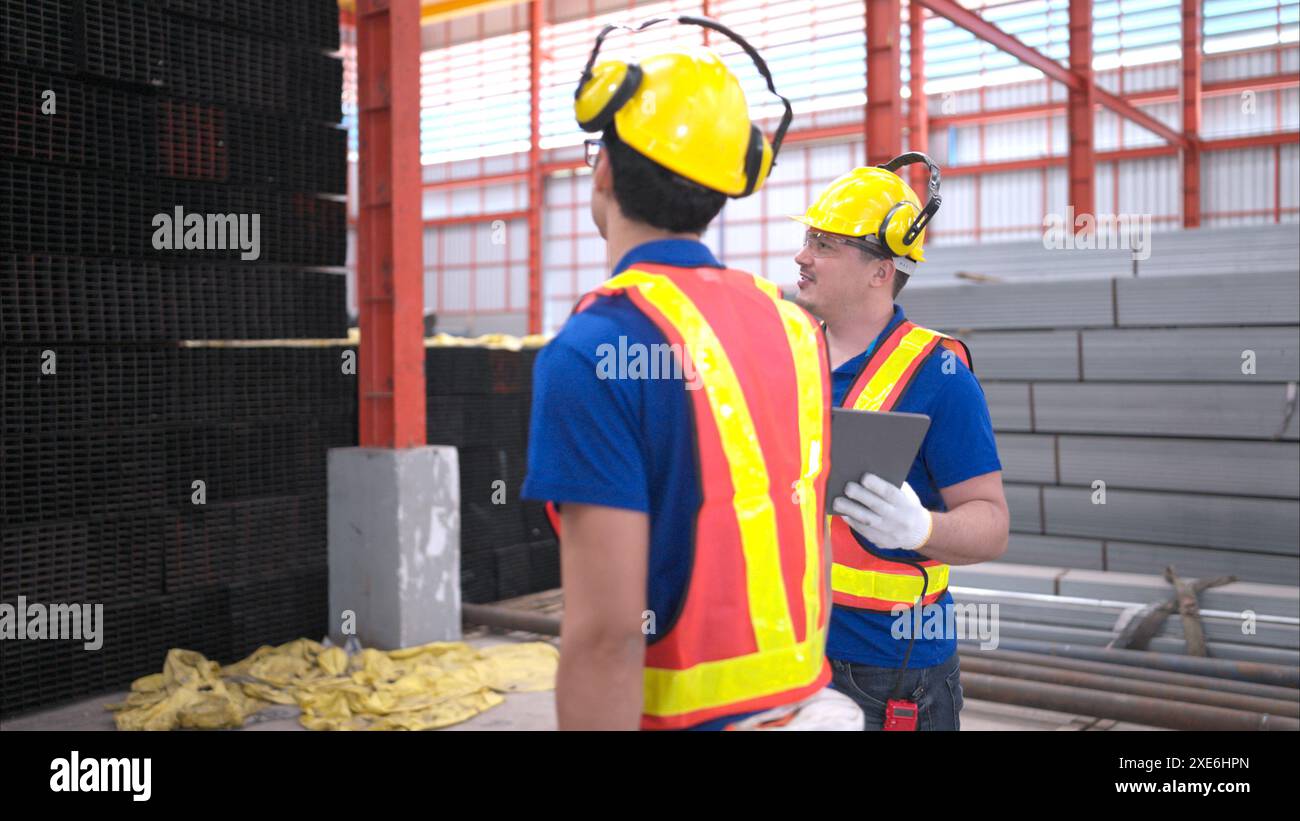 Warehouse workers in hard hats and helmets, Inspect and count steel in ...