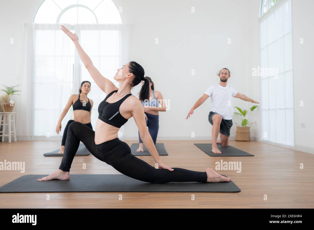 Group of people practicing yoga hi-res stock photography and images - Alamy