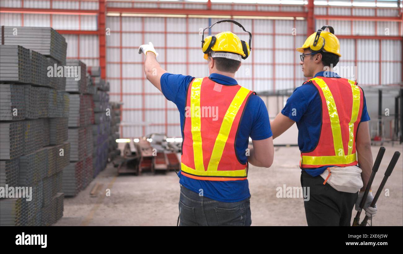 Warehouse workers in hard hats and helmets, Inspect and count steel in ...
