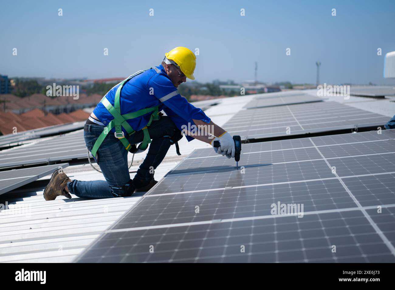 Both of technicians is installing solar panels on the roof of the ...