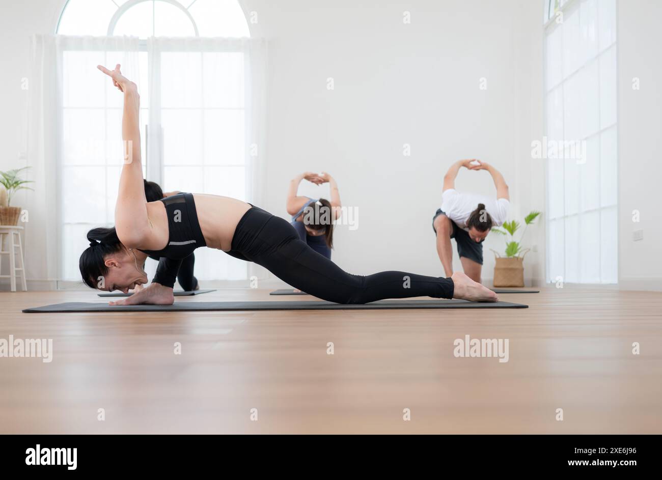 Group of people practicing yoga hi-res stock photography and images - Alamy