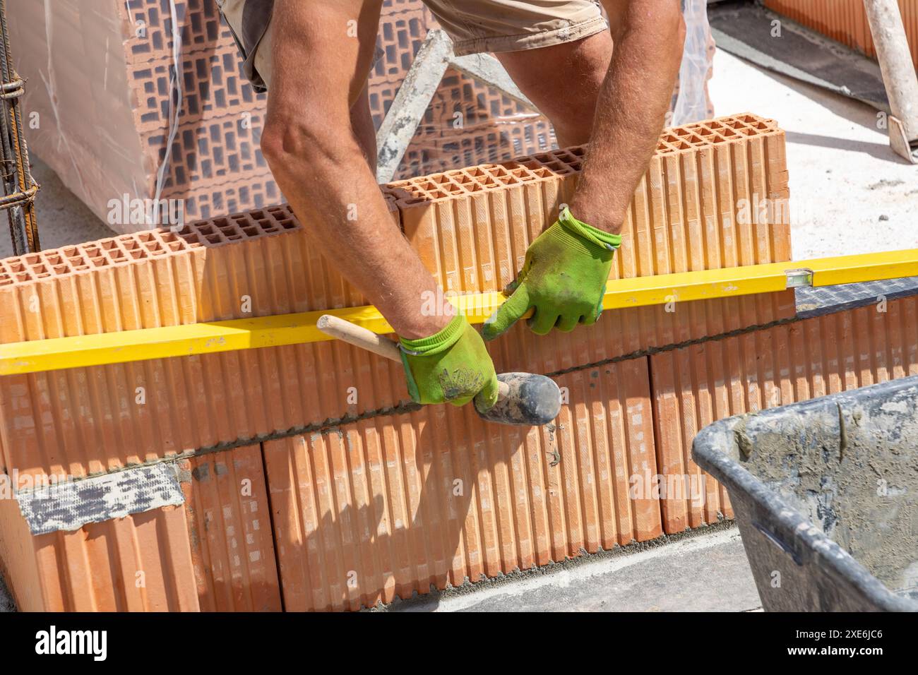 detail of cellar wall insulation at the construction site with worker ...