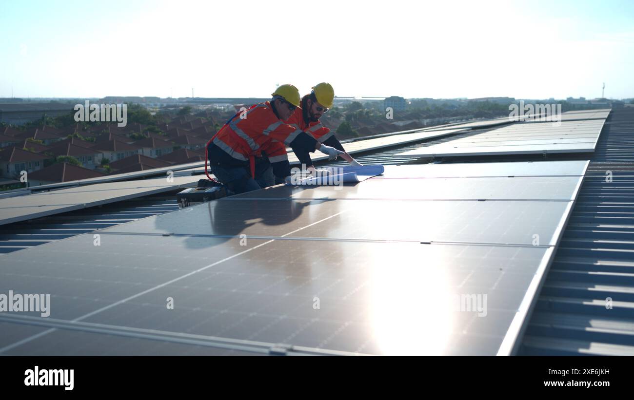 Engineer and technician working on the solar panel on the warehouse ...