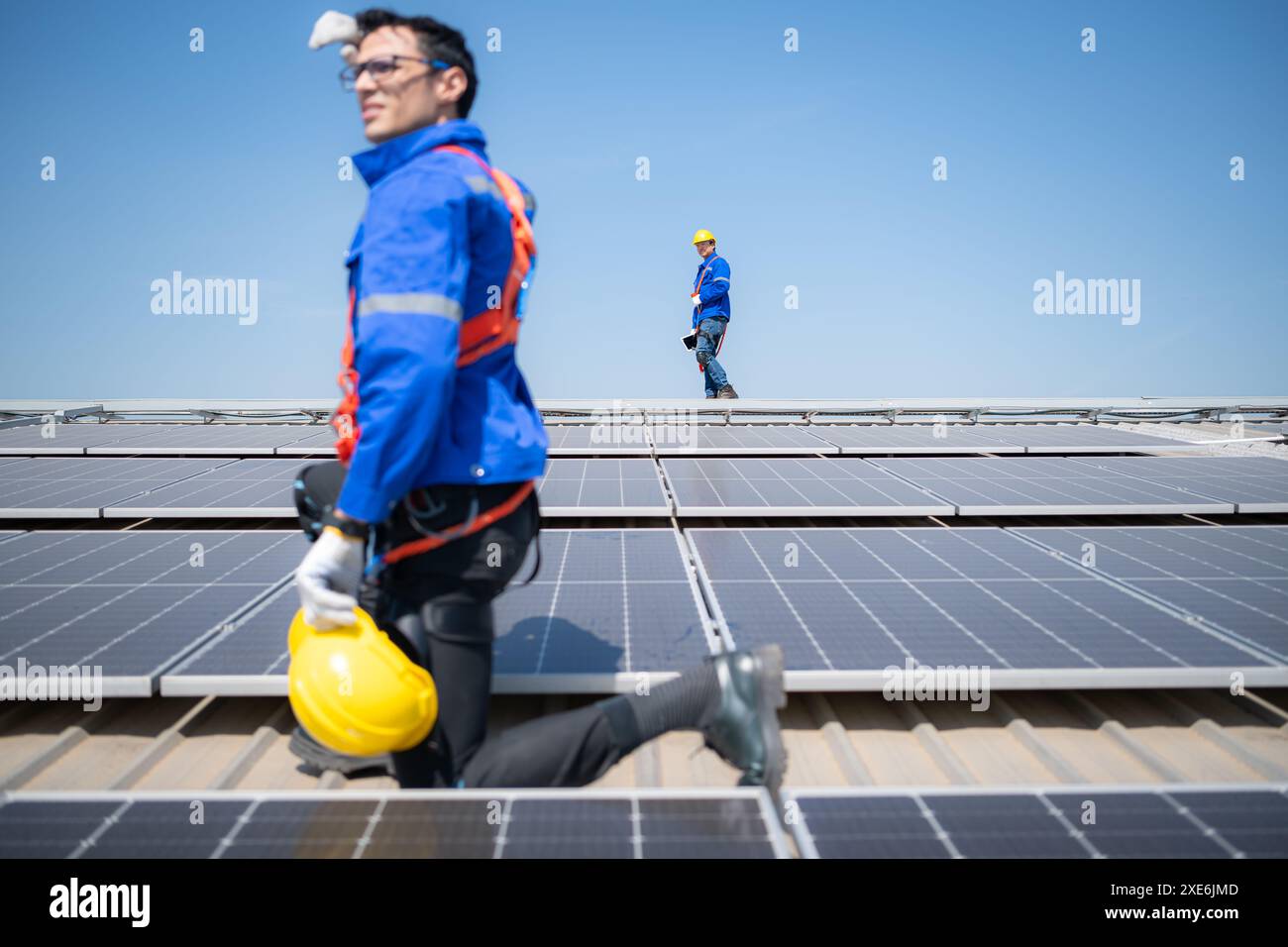 Technician repairing solar panels take off his hat and rest in the ...