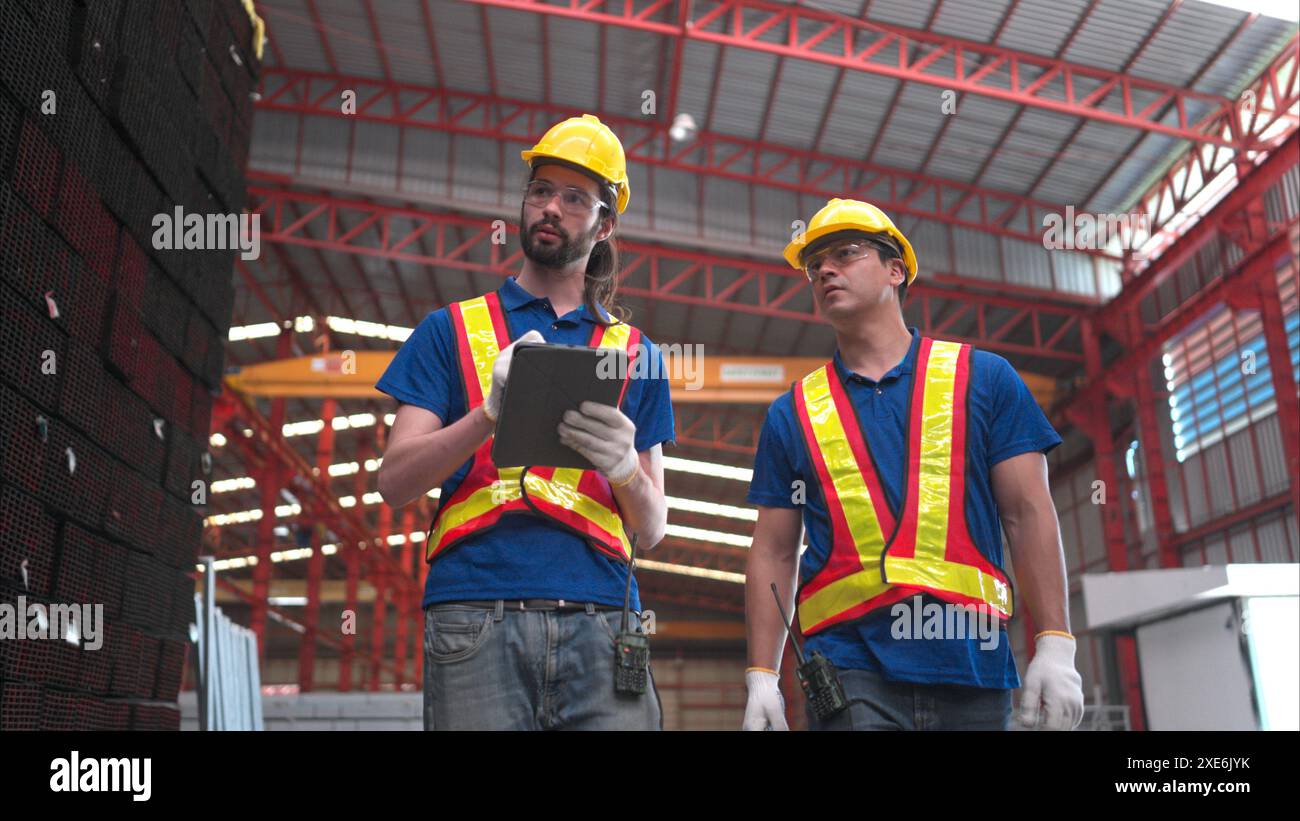 Warehouse workers in hard hats and helmets, Inspect and count steel in ...
