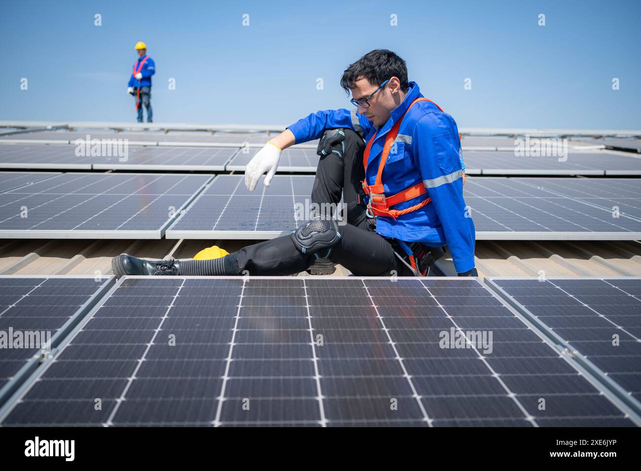 Technician repairing solar panels take off his hat and rest in the ...