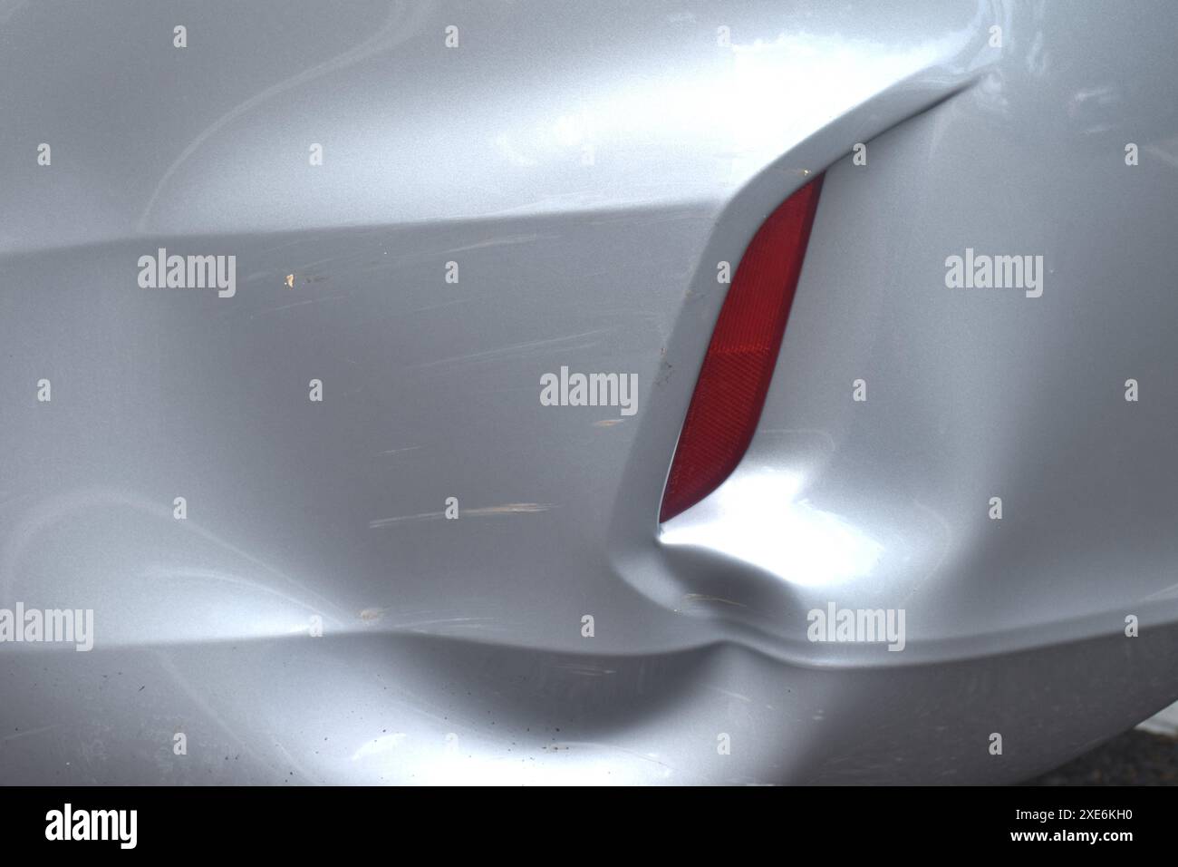 pound and scratch from accident on bumper of silver color car ...