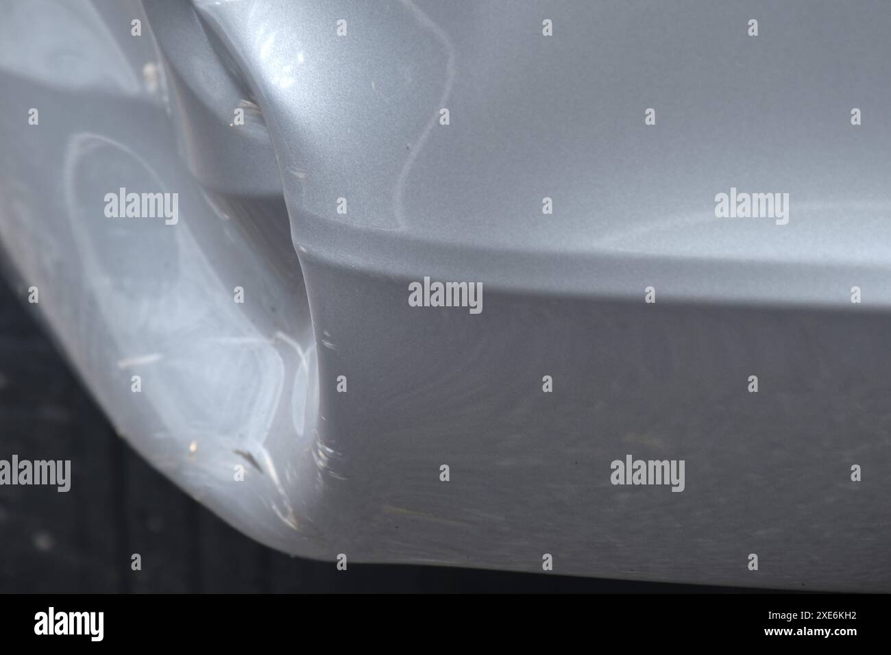 pound and scratch from accident on bumper of silver color car ...