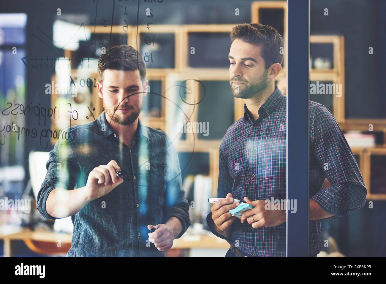 Glass board, business people or men with teamwork, brainstorming or ...