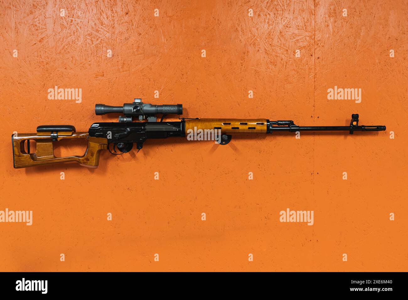 Russian sniper rifle SVD on an orange background at a shooting range ...