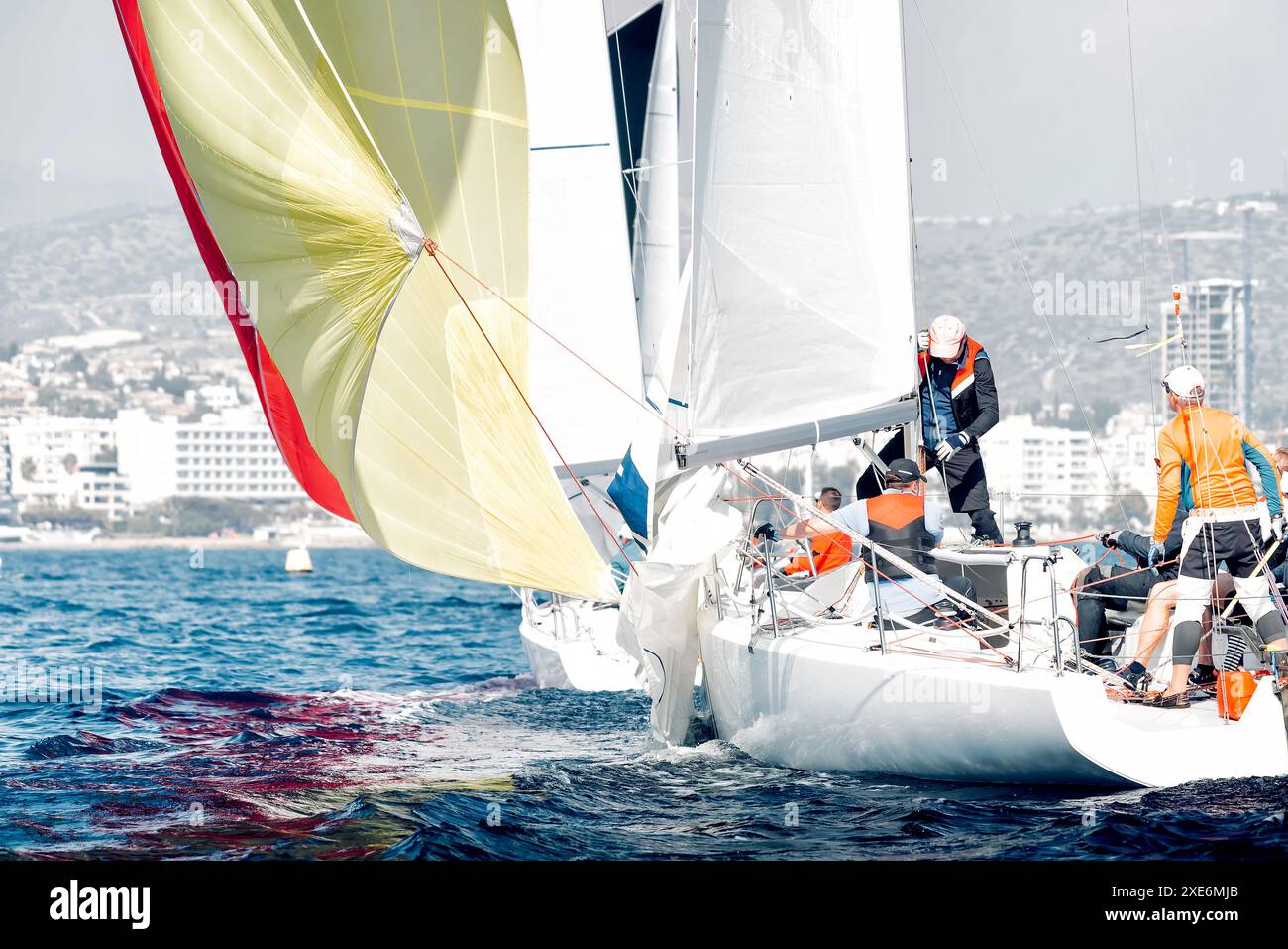 Sailing team is maneuvering on sailboat during regatta competition ...