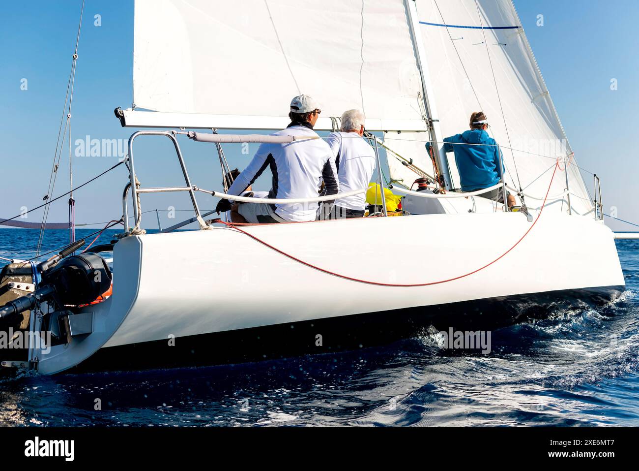 Sailing team navigating a yacht on the sea during a regatta competition ...