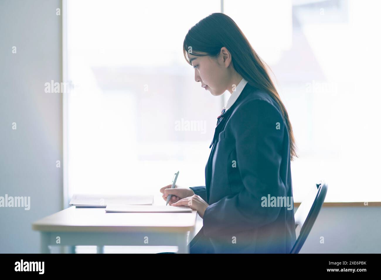 High school girl in profile taking notes Stock Photo - Alamy