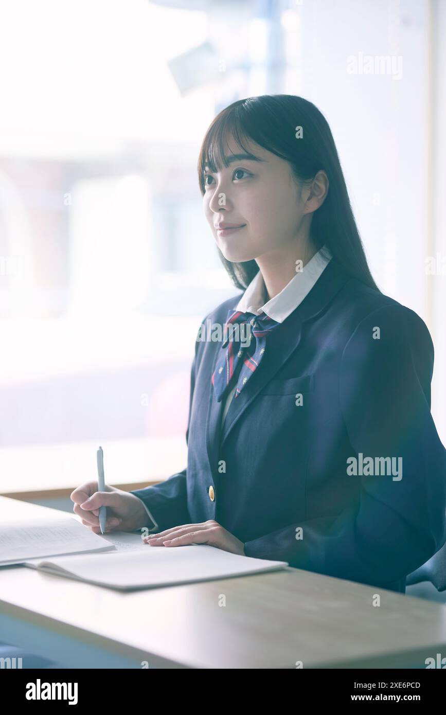 Female high school student taking notes Stock Photo - Alamy