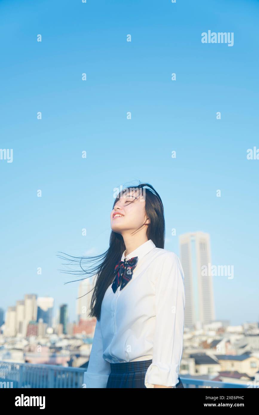 Student on the rooftop looking up at the sky comfortably Stock Photo ...