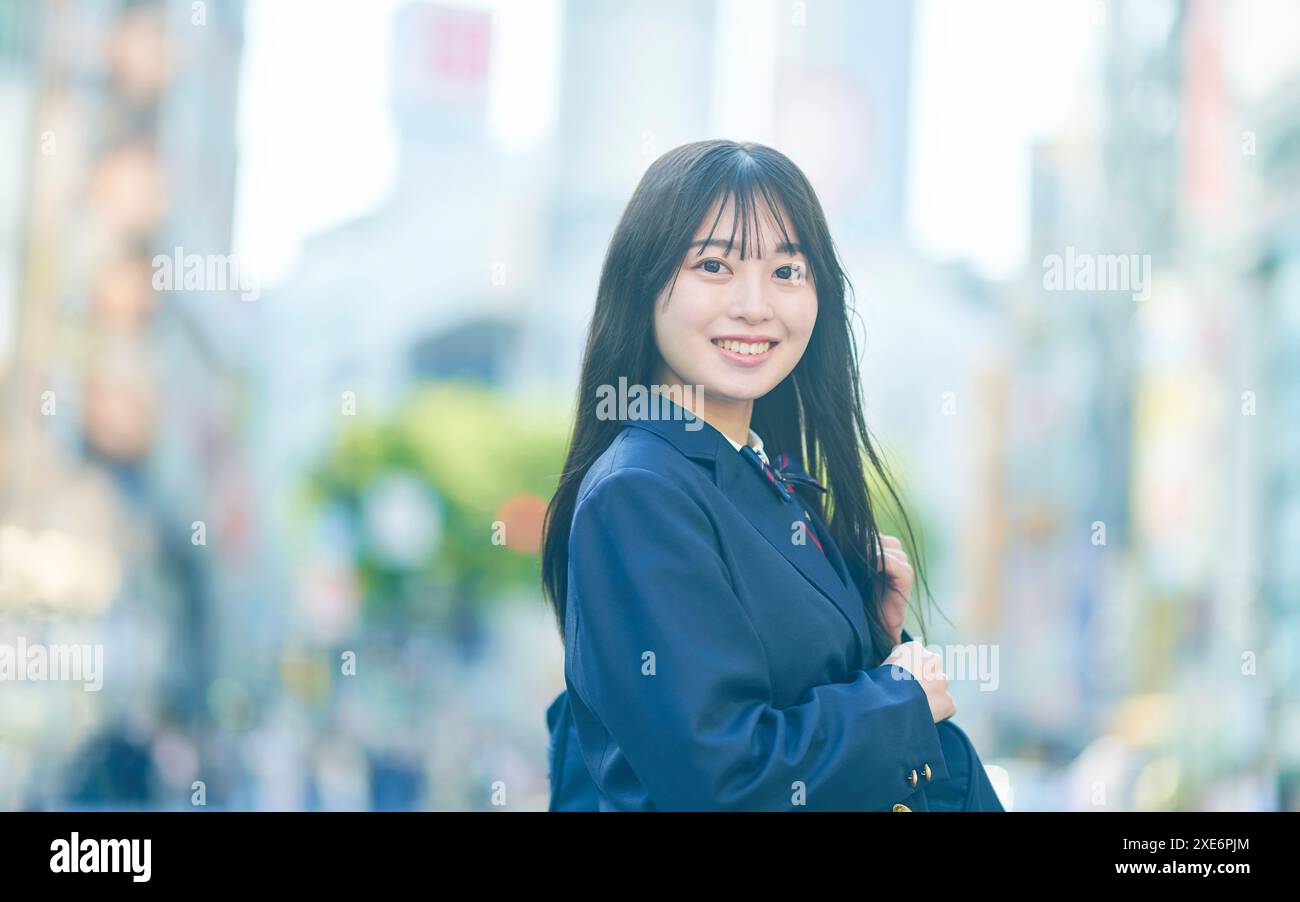 Student looking back at you in the street Stock Photo - Alamy