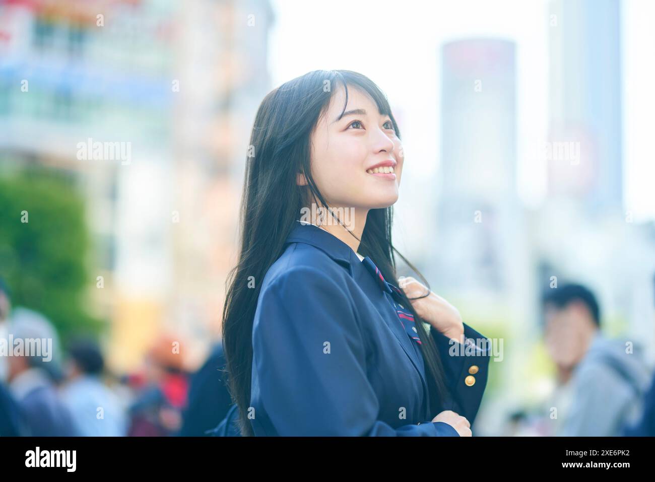 Student looking up at the sky in the street Stock Photo - Alamy