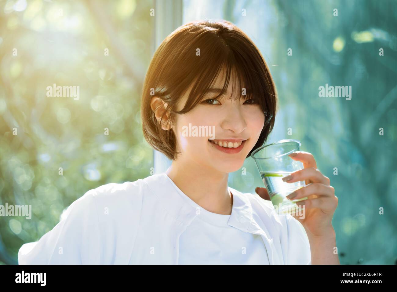 Young woman gulping water in amazement Stock Photo - Alamy