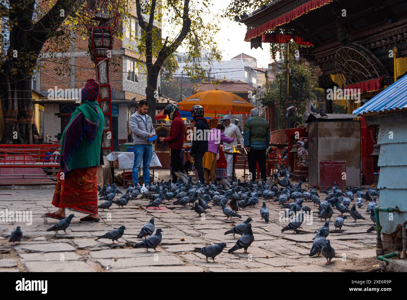 Devotees and prayers in front of a Hindu temple with religious people ...