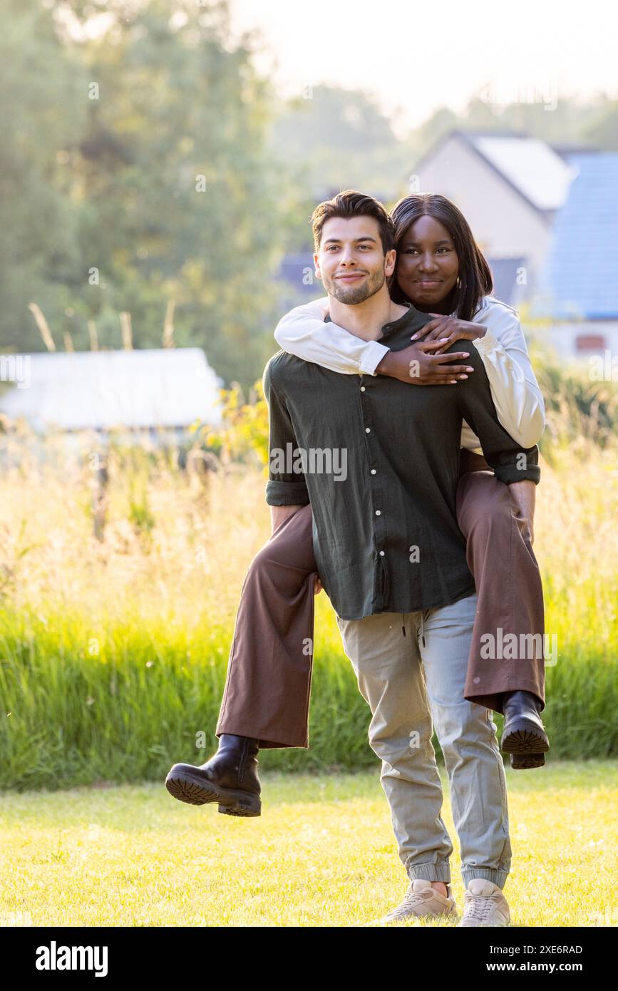 Joyful Couple Enjoying a Piggyback Ride Outdoors Stock Photo - Alamy