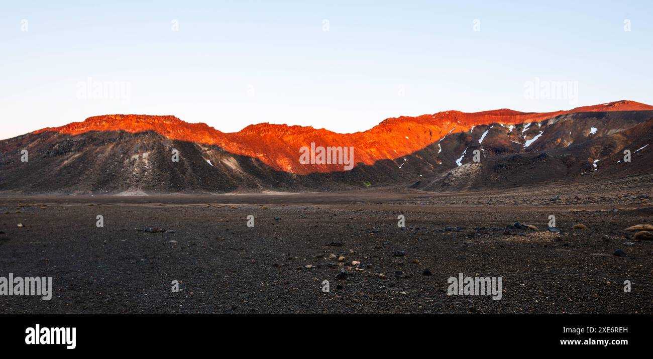 Walls of Tongariro Volcano lit by red sunrise, volcanic plains of New ...
