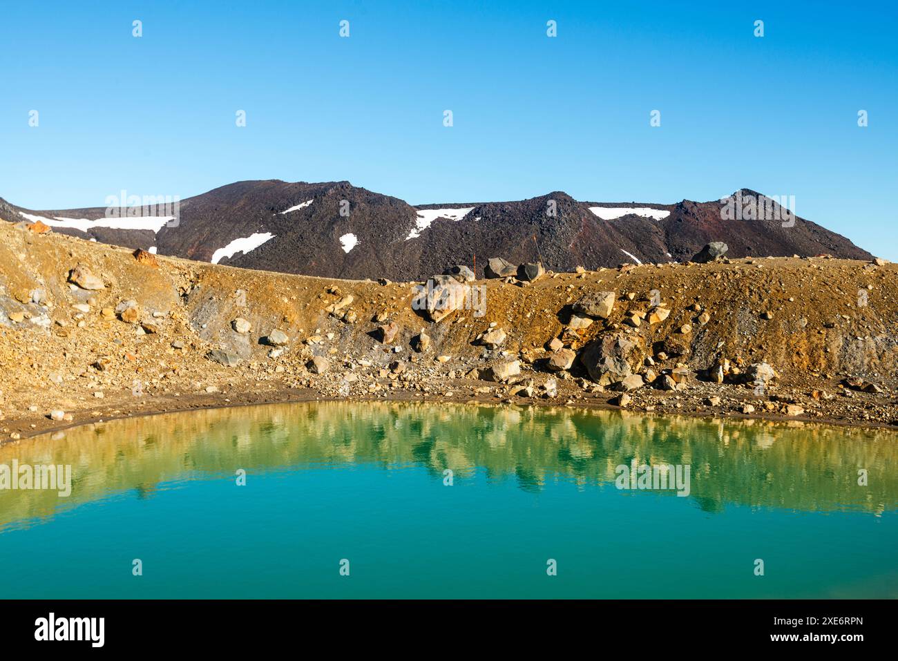 Turquoise and yellow green Emerald Lake in front of the Tongariro ...